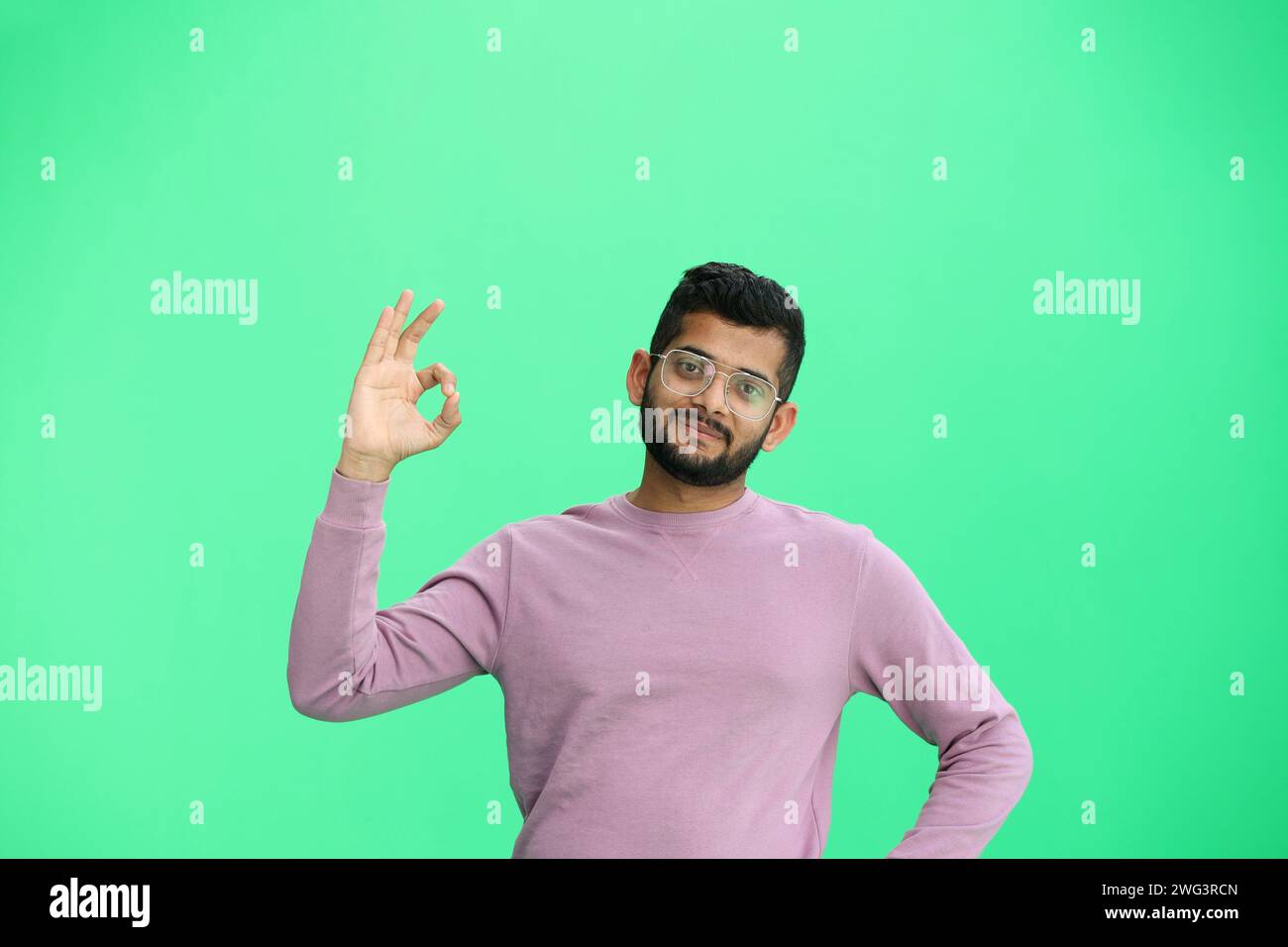 A man, on a green background, in close-up, shows an ok sign Stock Photo ...