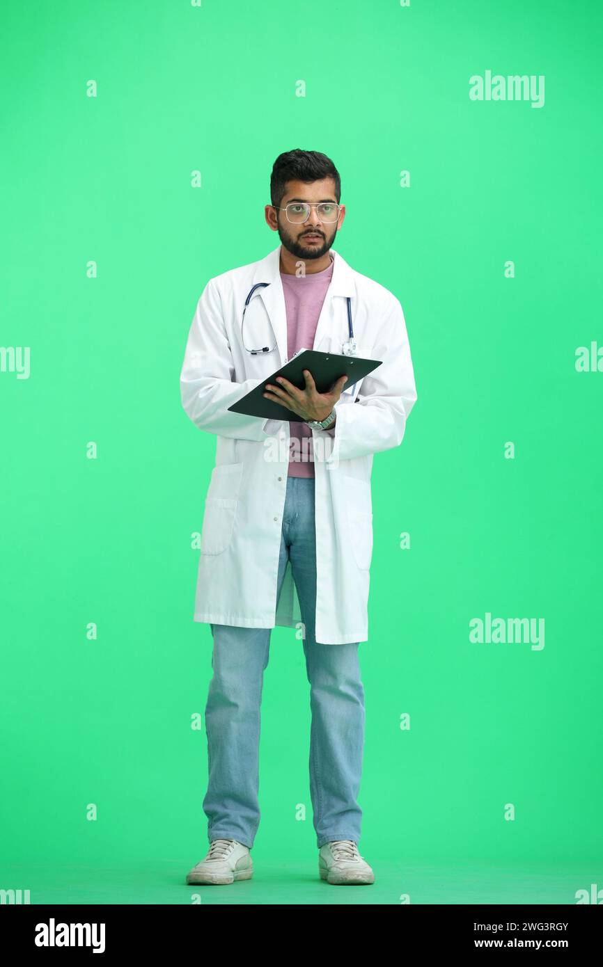 Doctor on green background writes hi-res stock photography and images ...