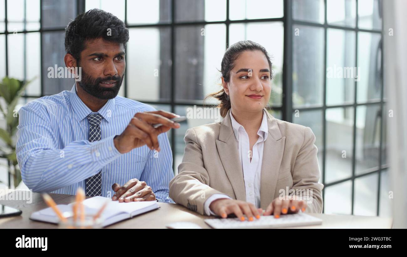 Young indian mentor coach talking with female colleague teaching ...