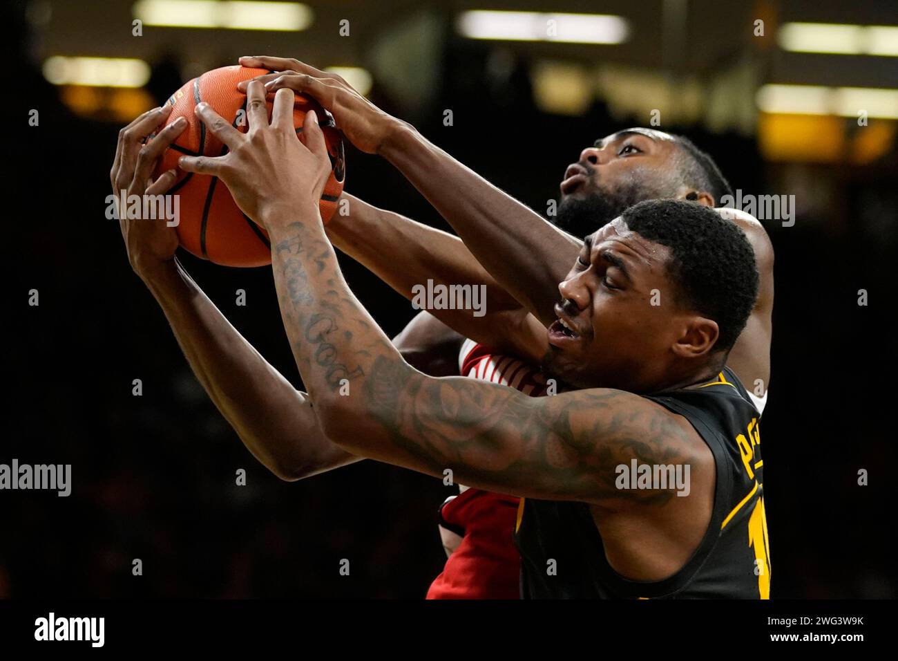 Iowa guard Tony Perkins fights for a rebound with Ohio State guard Evan ...