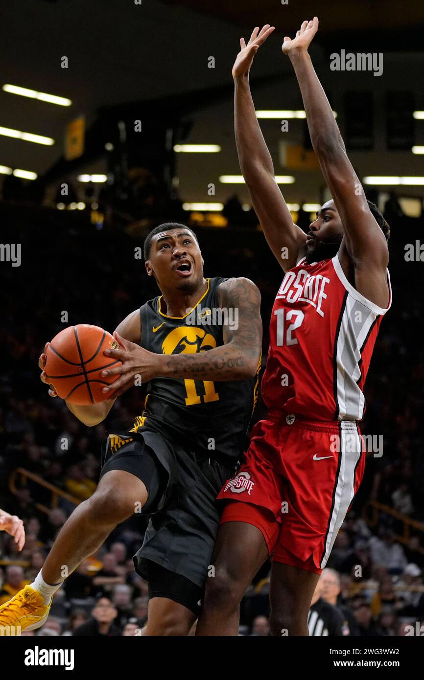 Iowa guard Tony Perkins (11) drives to the basket past Ohio State guard ...