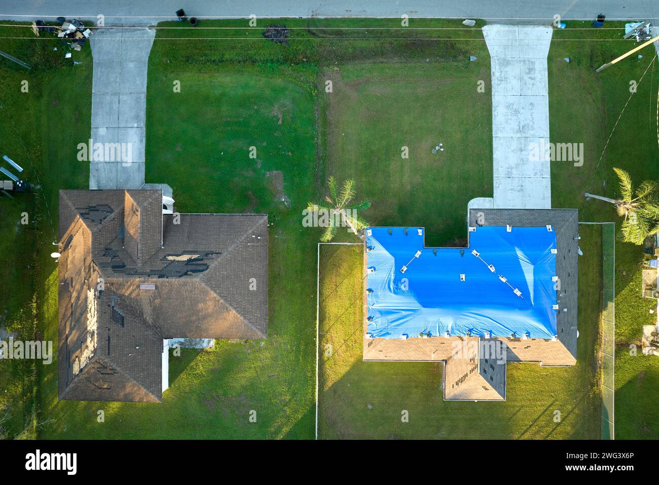 Top view of leaking house roof covered with protective tarp sheets ...