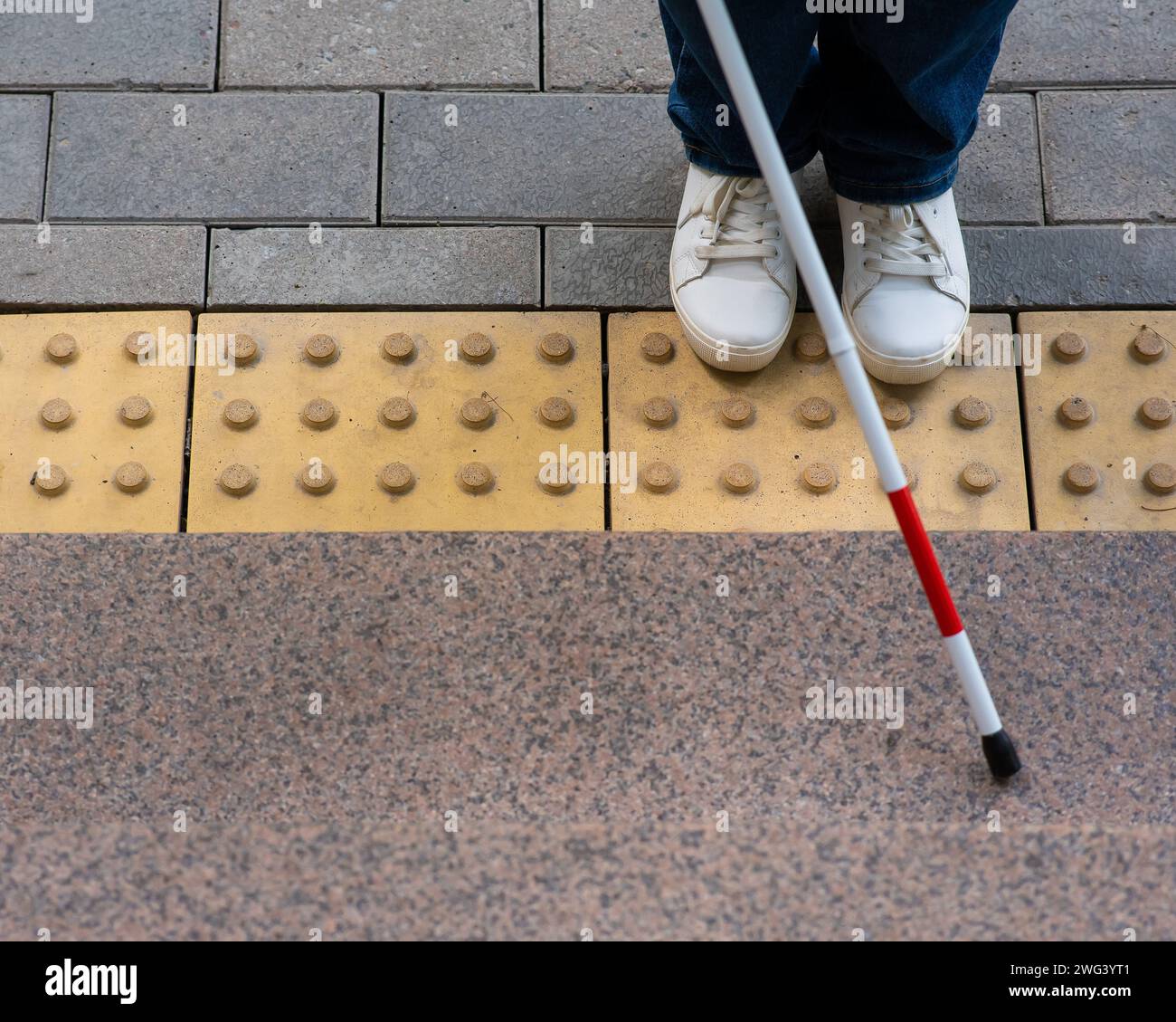 Blind woman walking outdoors using a tactile cane Stock Photo - Alamy