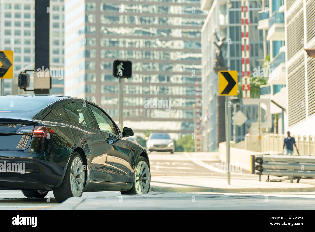 Electric car on American street at intersection with traffic lights in Miami, Florida ...