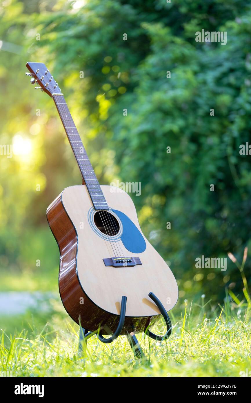 Acoustic guitar outdoors on greenery background. Concept of calm music ...