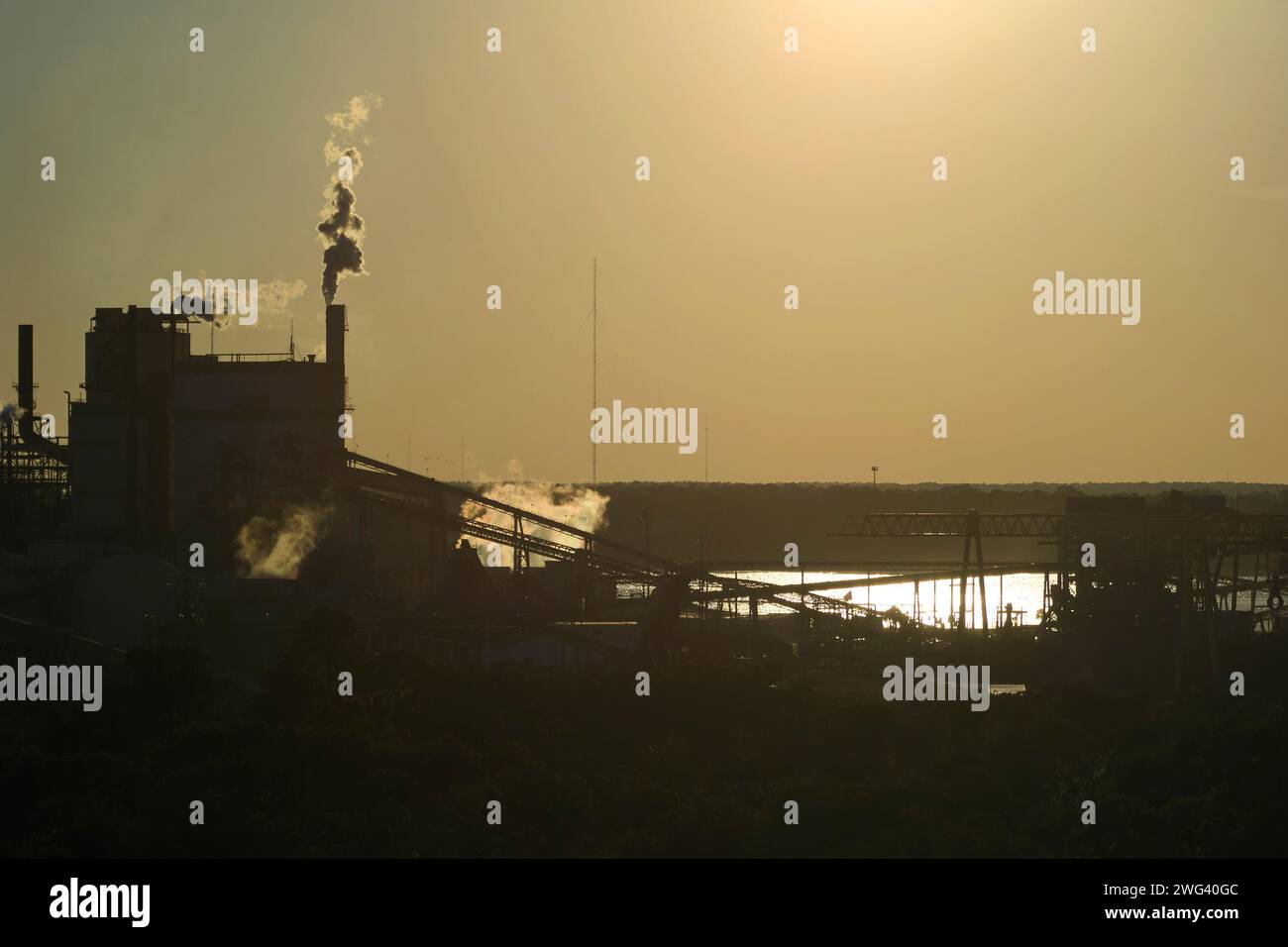 Aerial view of wood processing factory with smoke from production ...