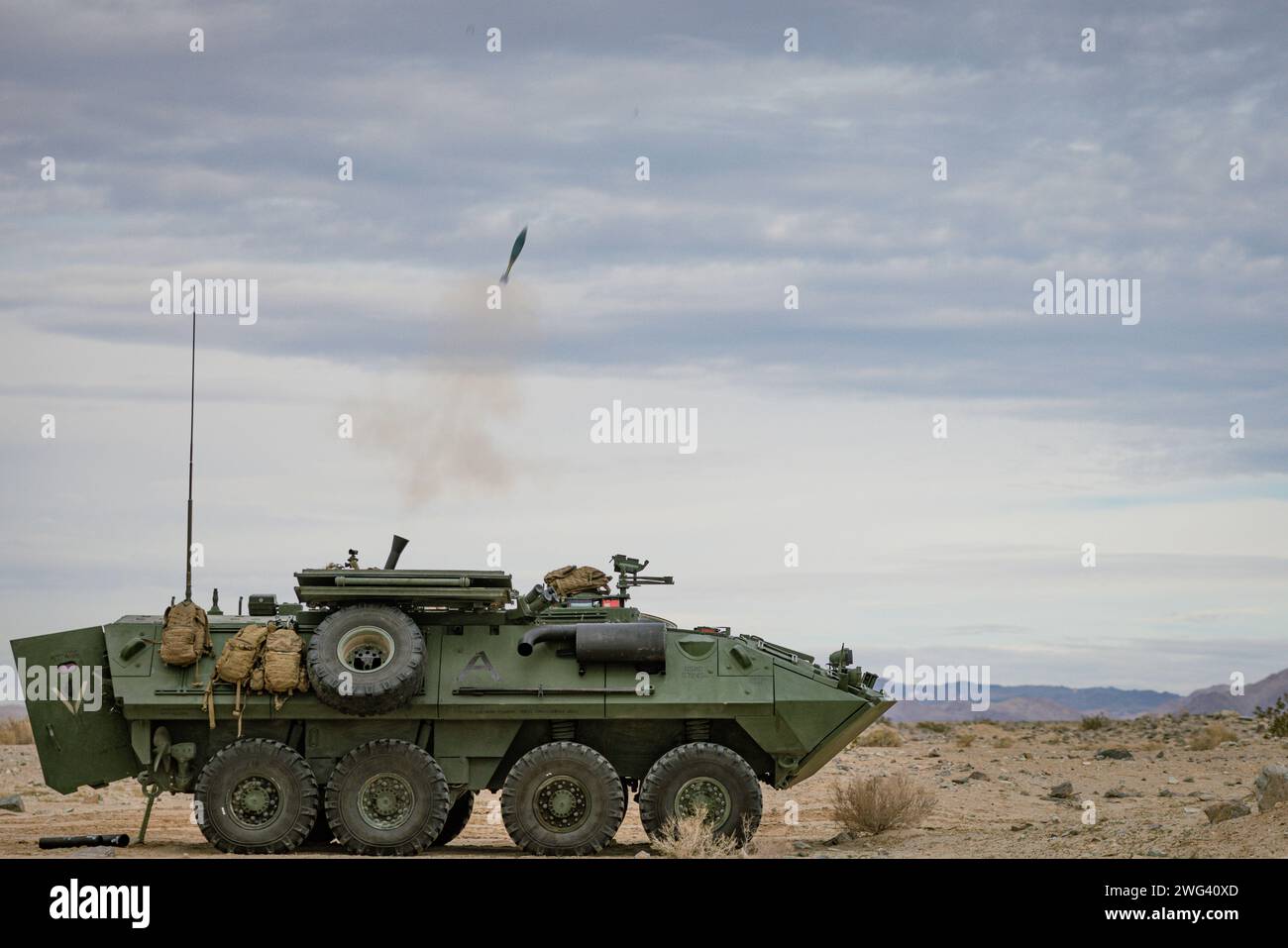 U.S. Marines with 1st Light Armored Reconnaissance Battalion, 1st Marine Division, fire an M252 ...