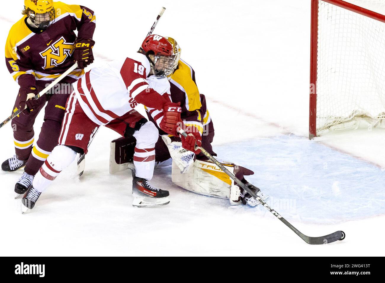 Wisconsin forward Quinn Finley (19) shoots the puck against Minnesota ...