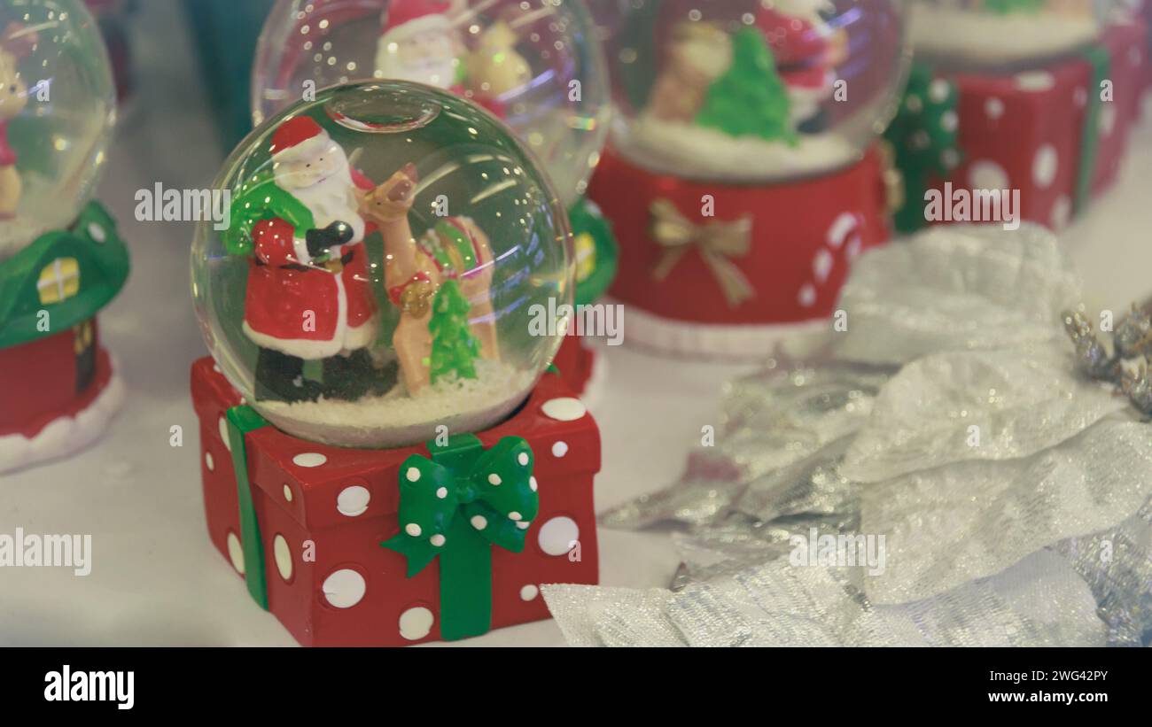 Snow globes featuring Santa Claus and a reindeer, seasonal Christmas ...