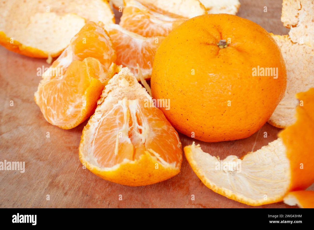 Pealed Mandarin oranges on wooden table background Stock Photo - Alamy