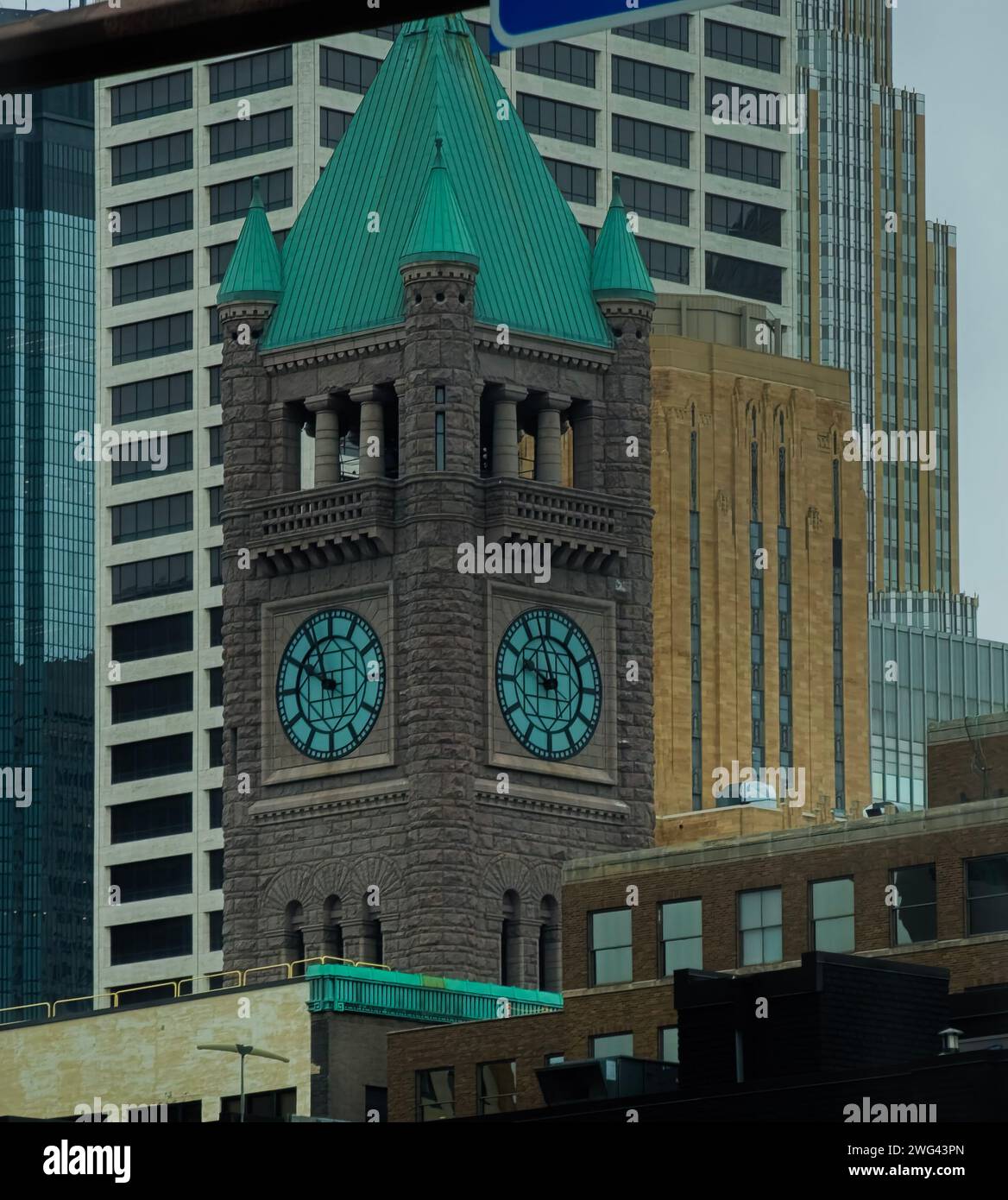 Clock Tower in Minneapolis surrounded by skyscrapers in a bustling city ...