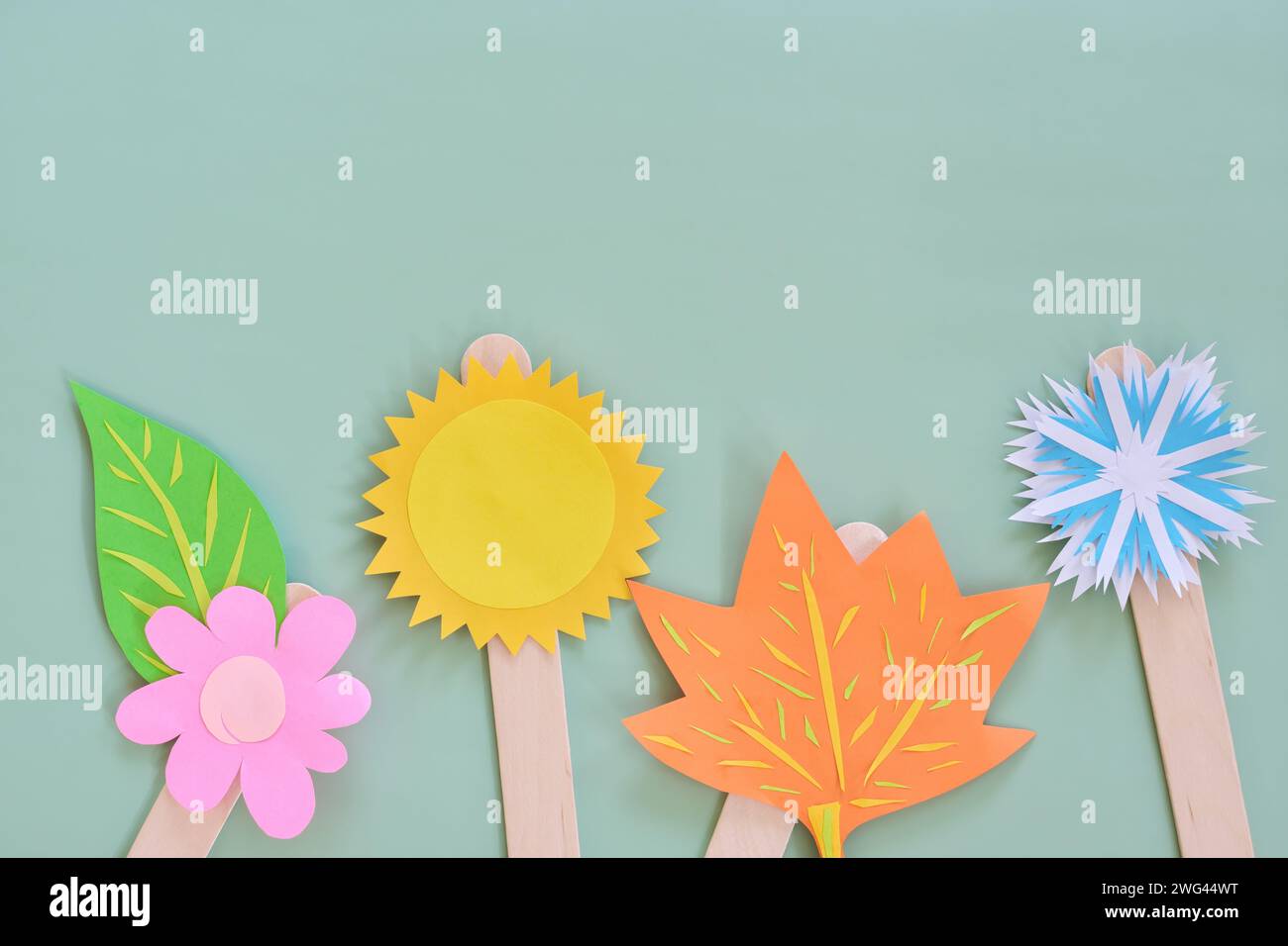 Four seasons flat lay composition icons on green background with copy ...