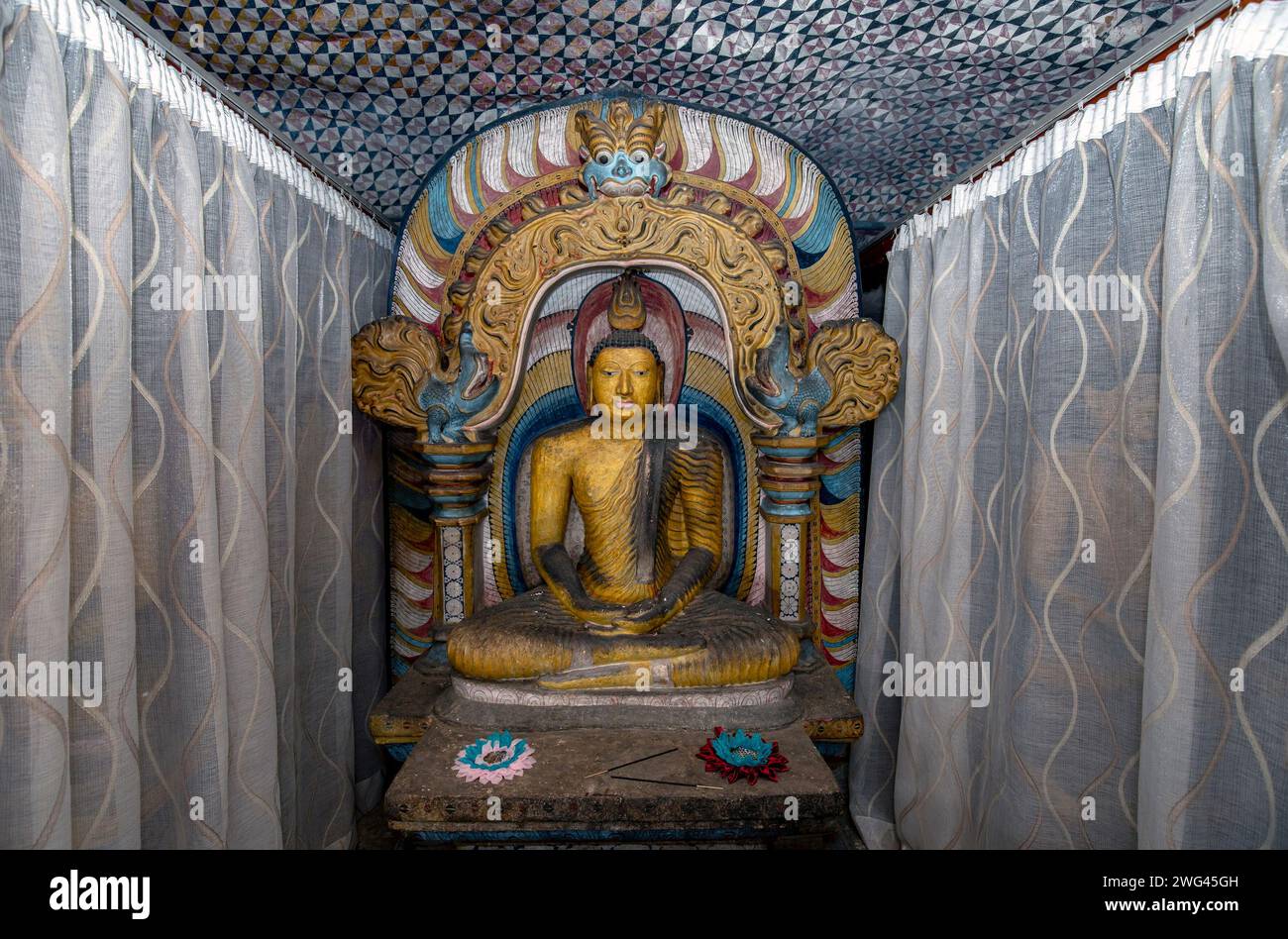Curtains surround a seated Buddha statue located in Cave Four (Pachima ...