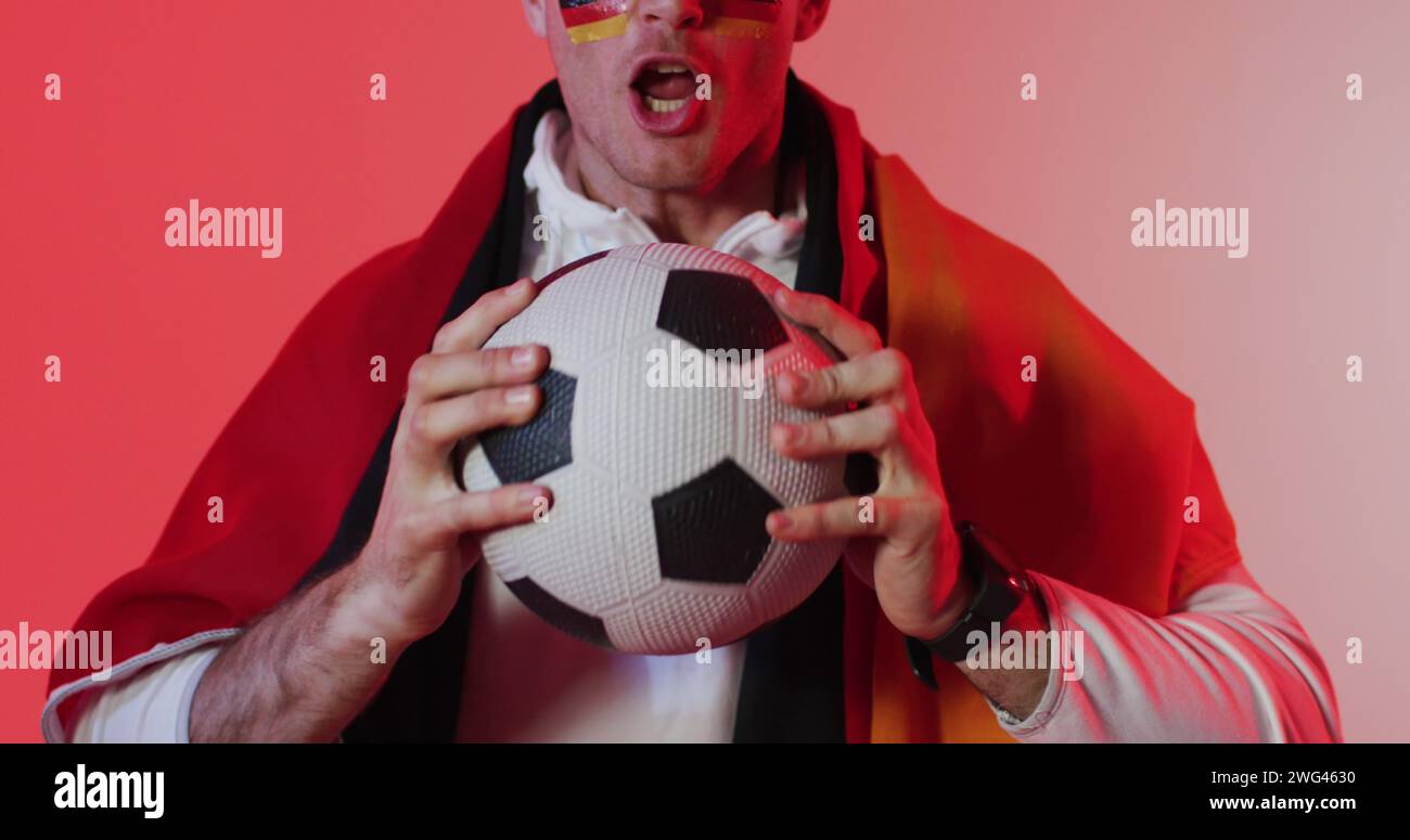 Young Caucasian man poses as a superhero with a soccer ball Stock Photo ...