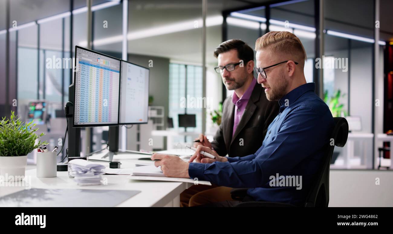 Using Corporate Invoice Spreadsheet On Computer Monitors Stock Photo ...