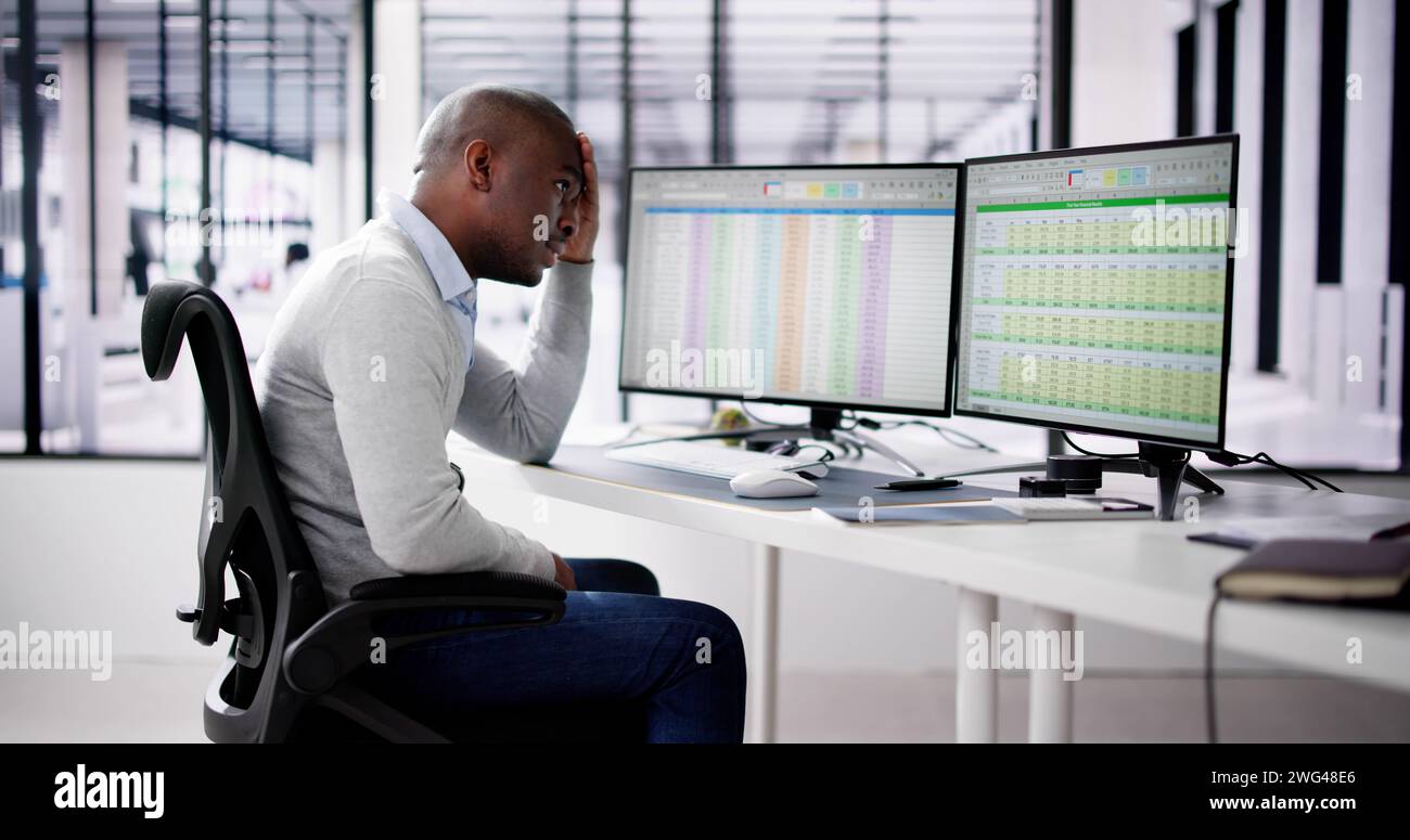 Data Analyst African Man Using Spreadsheet On Computer Stock Photo - Alamy