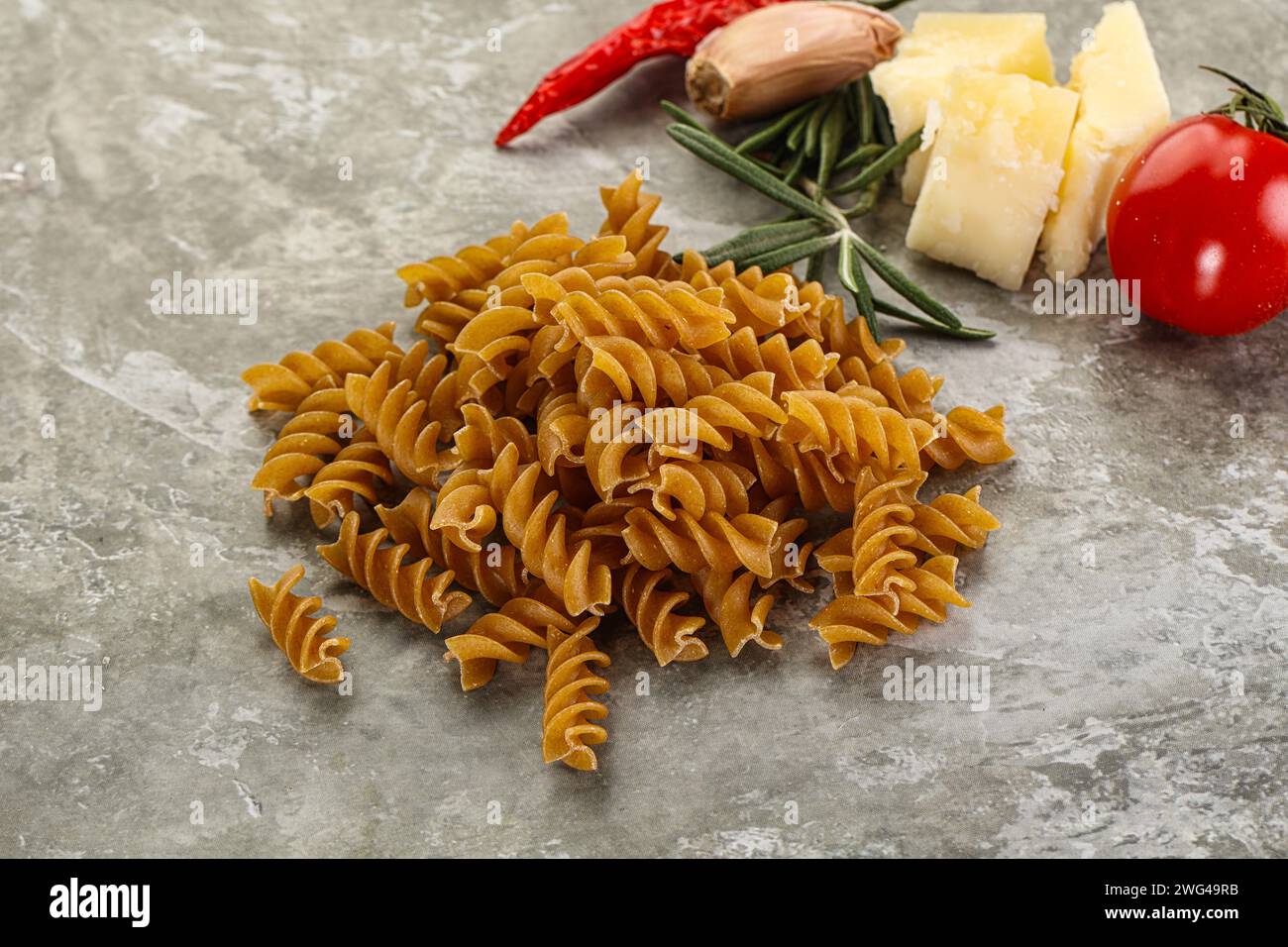 Raw dietarywhole grain pasta fusilli for bowl Stock Photo - Alamy