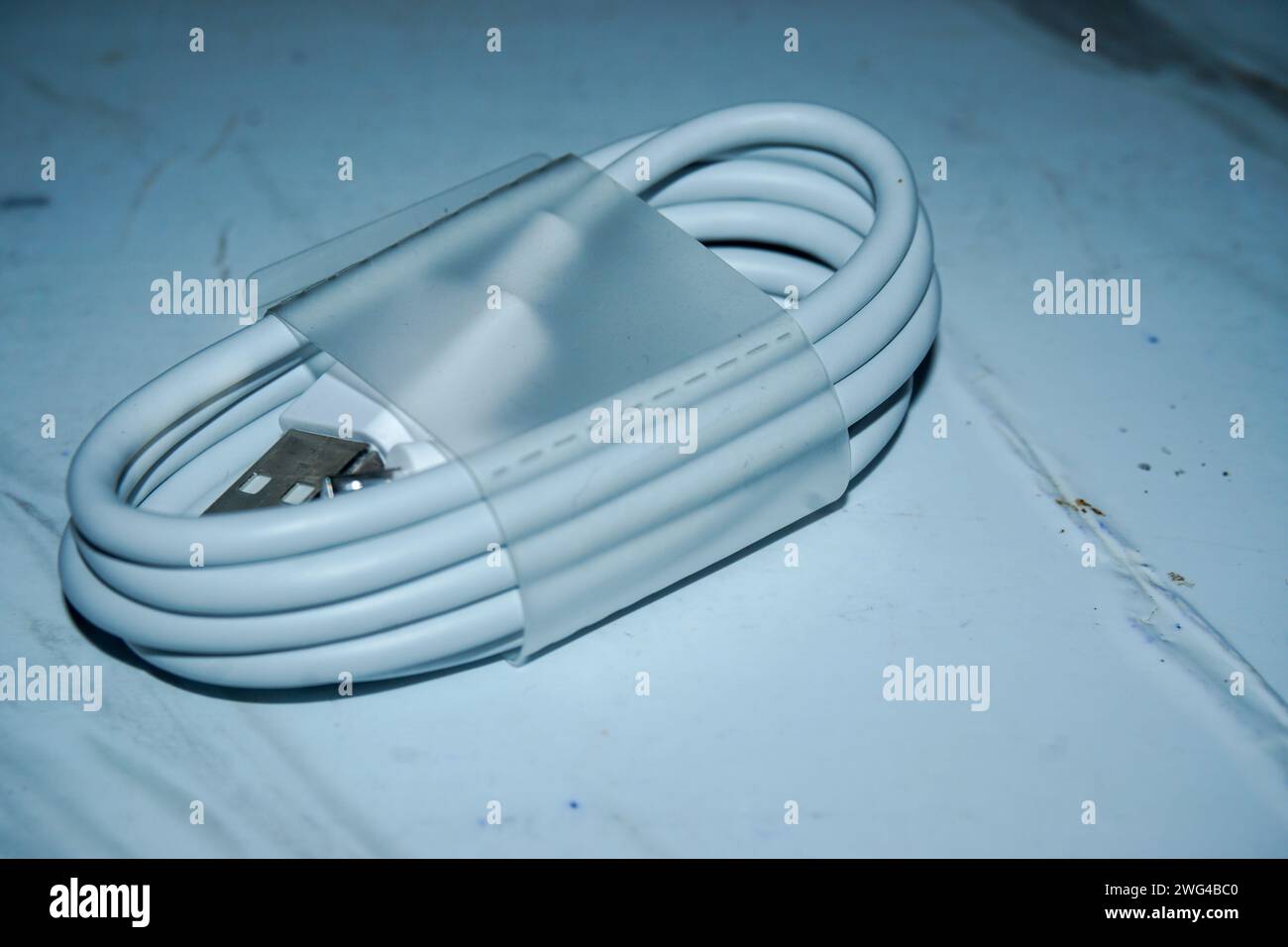 Flat lay white smartphone charger cable Stock Photo - Alamy