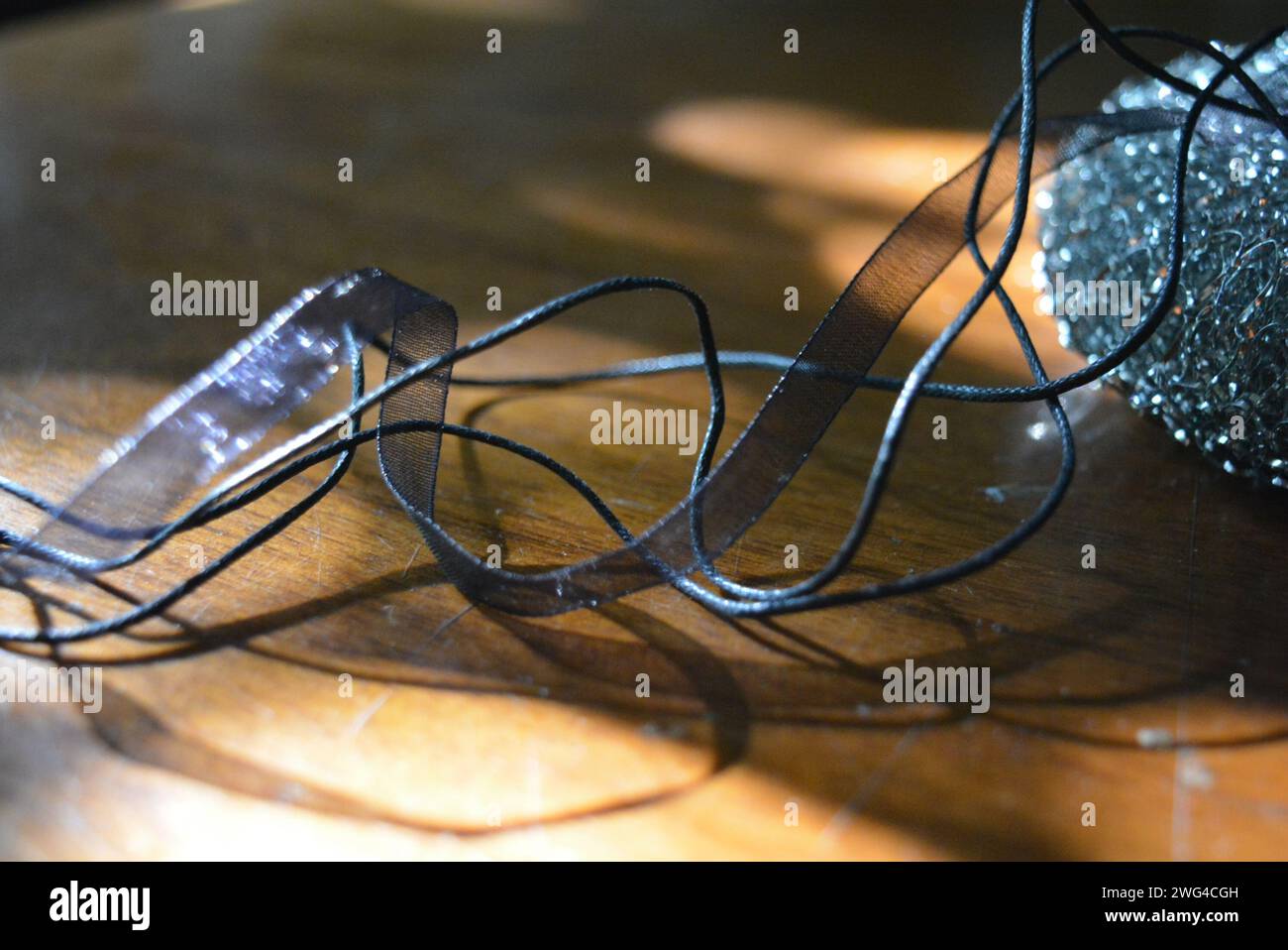 Metal sponge with a transparent black ribbon and black threads on a ...