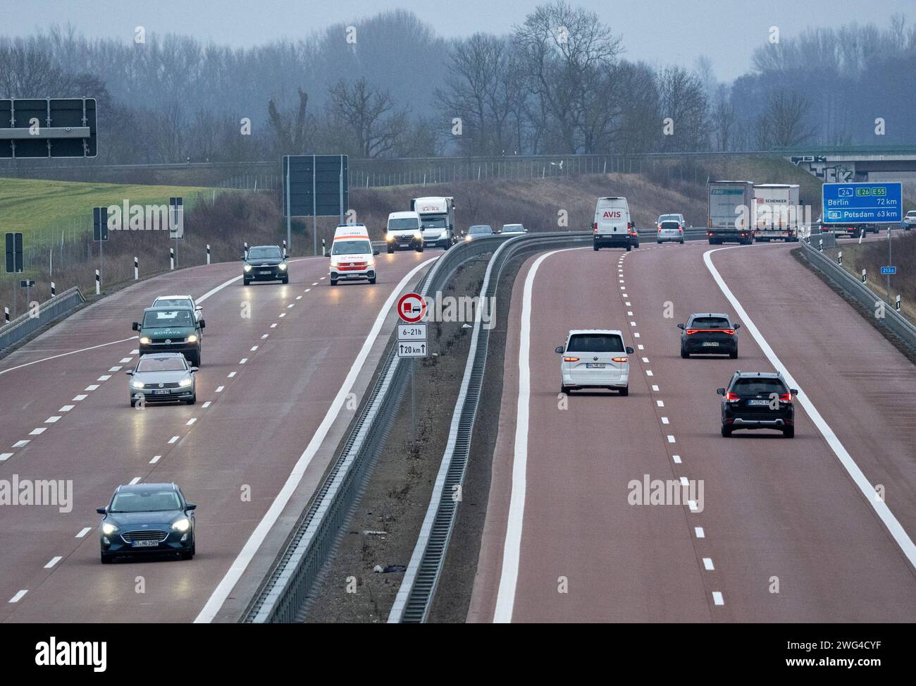 02 February 2024, Brandenburg, Neuruppin: Cars and trucks drive near ...