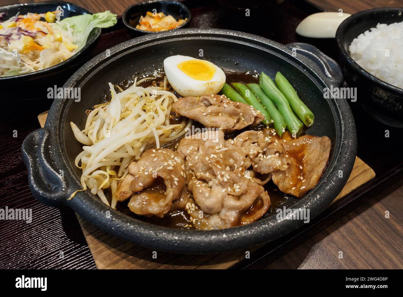 pork teppanyaki with egg and vegetables in hot plate Japanese Cooking ...