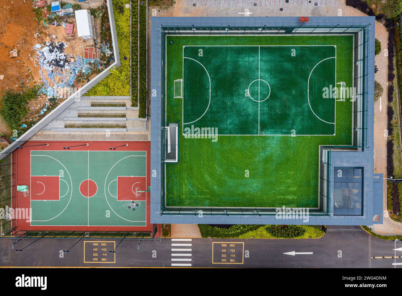An aerial view of a football field on a rooftop next to a high-tech ...