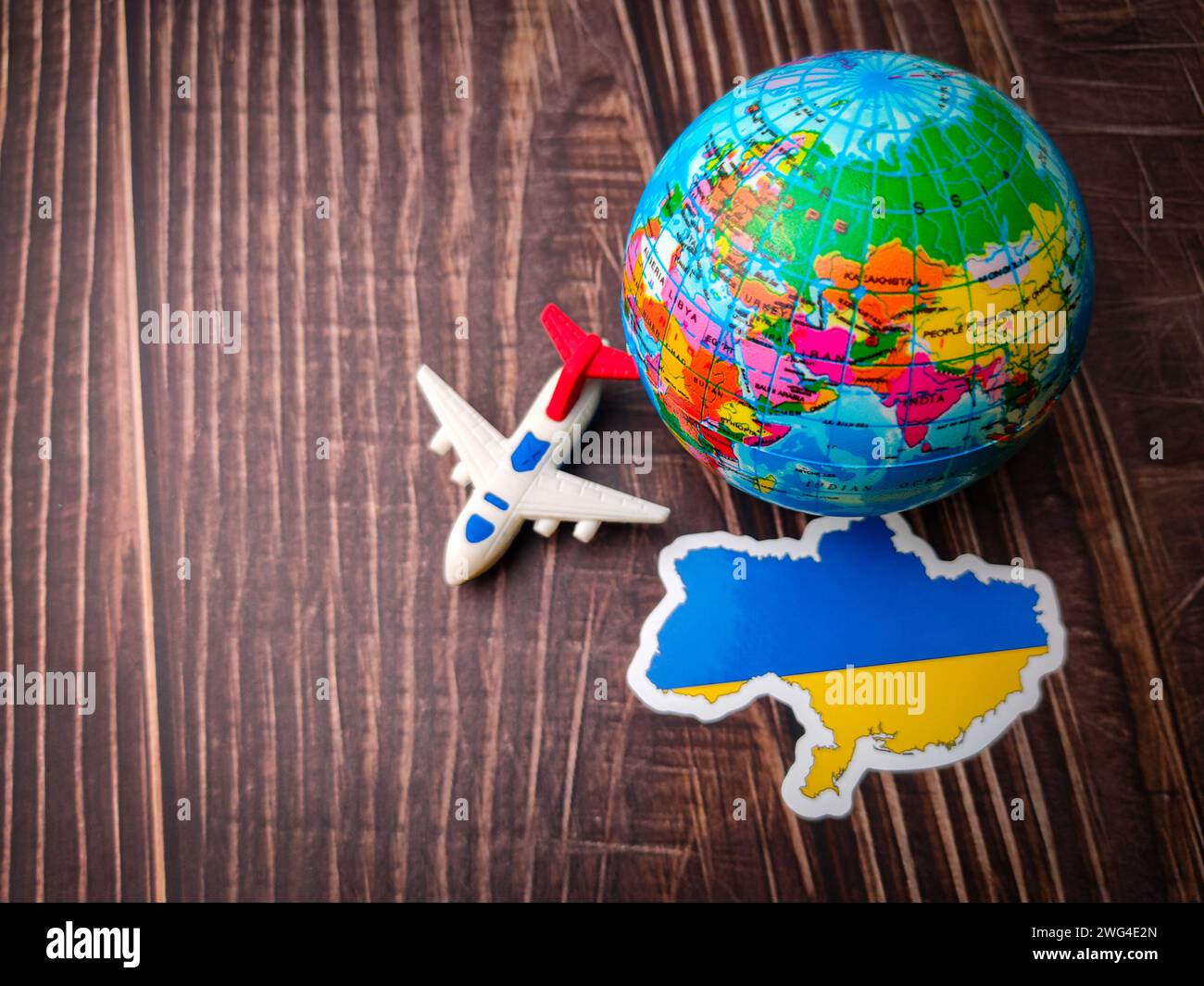 Top view ukraine flay,toys plane and earth globe on wooden background ...