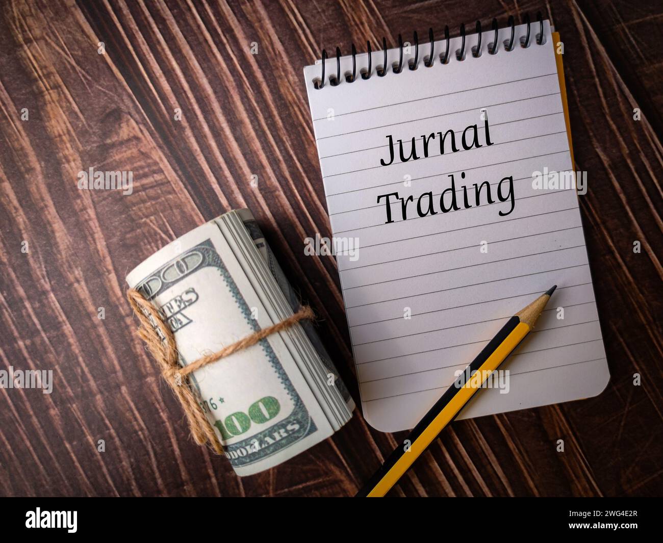 Top view banknotes,notebook and pencil with text Jurnal Trading on ...