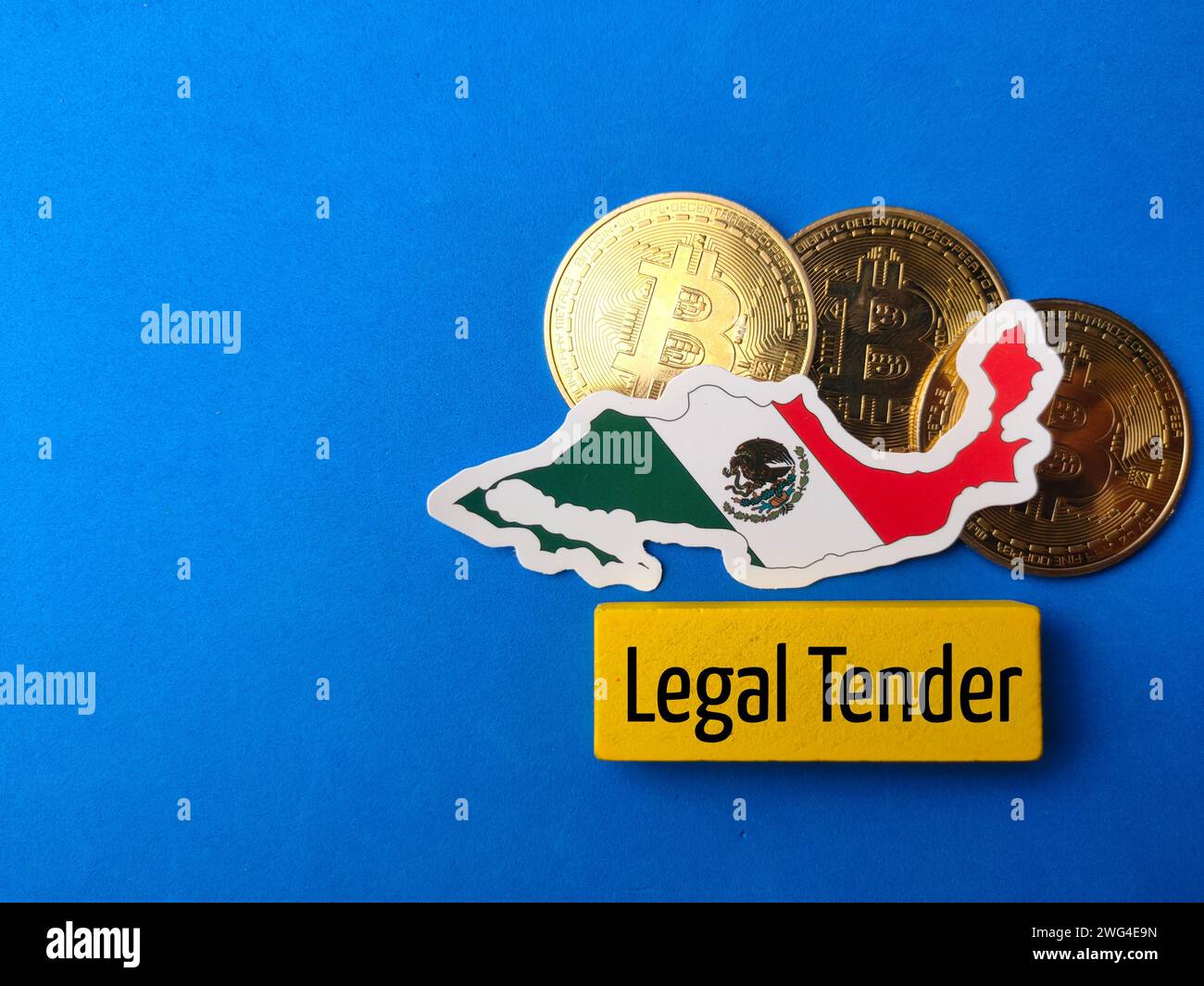 Top view bitcoins and mexico flag with text Legal Tender on blue ...