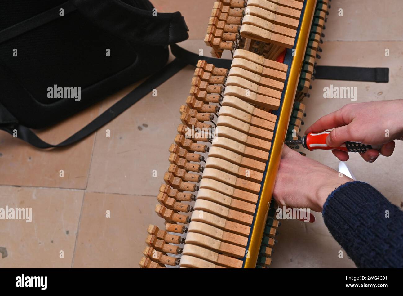 The tuner adjusts the disassembled piano using the instrument Stock ...