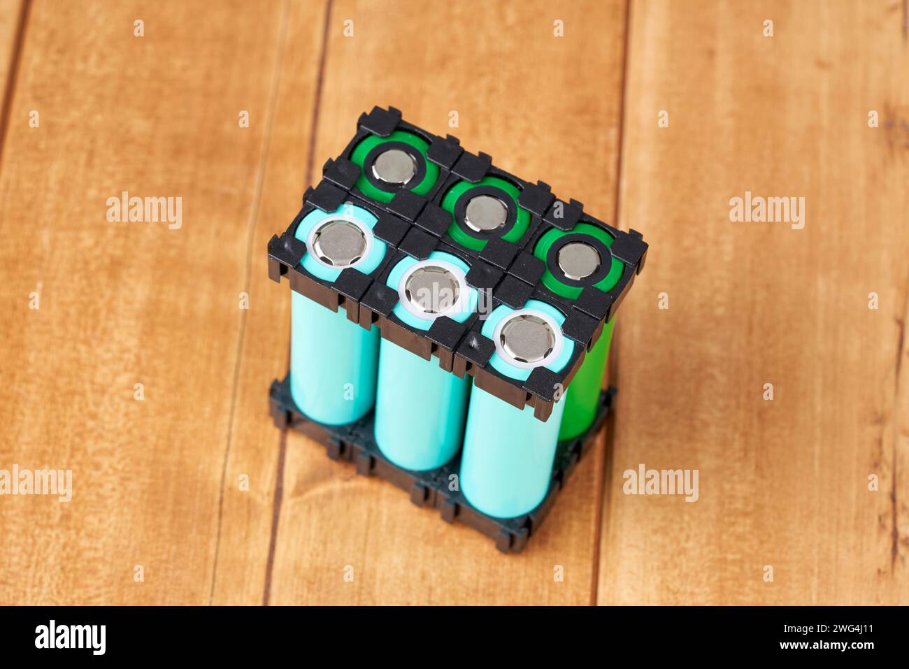 Lithium battery pack in black plastic holder wooden table Stock Photo ...