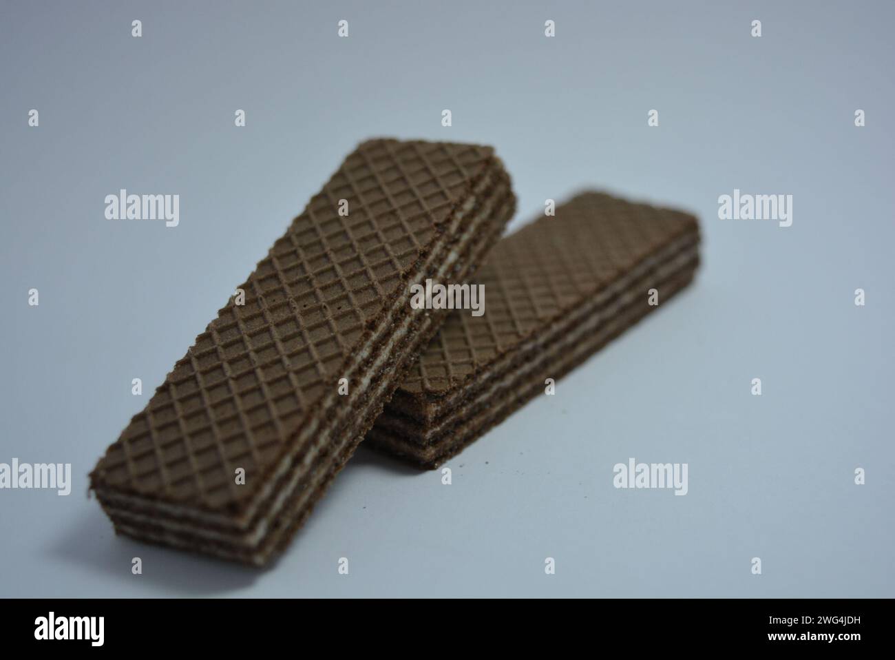 On white paper sweet chocolate wafers with white coconut filling Stock ...