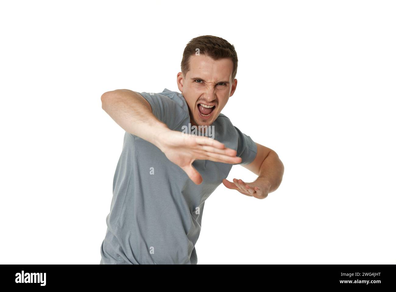 annoyed angry man fighting on white studio background Stock Photo - Alamy