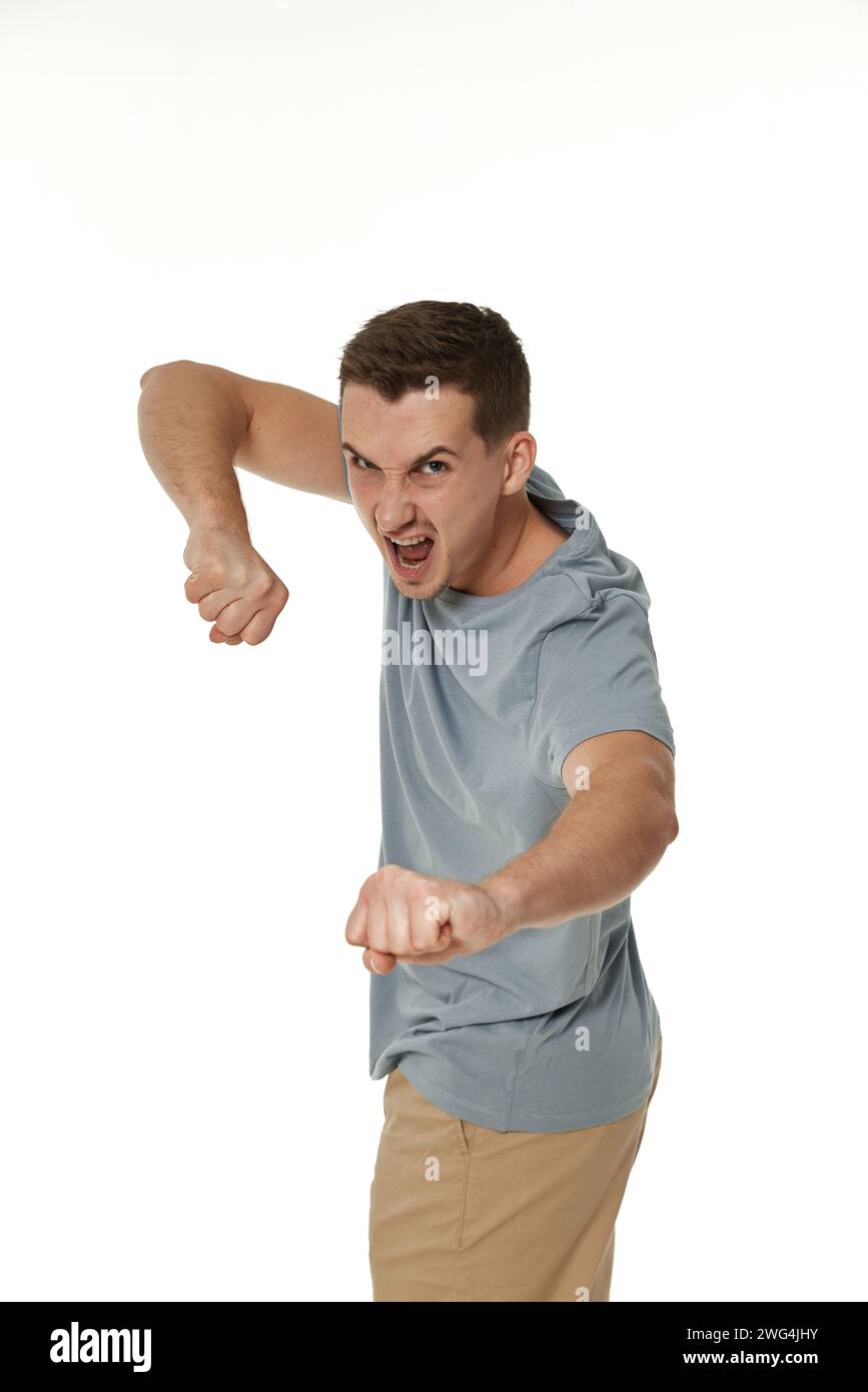 annoyed angry man fighting on white studio background Stock Photo - Alamy
