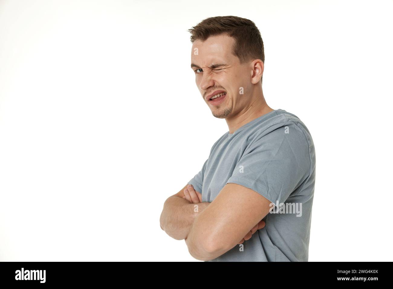 portrait of young happy man winking looking at the camera on white ...