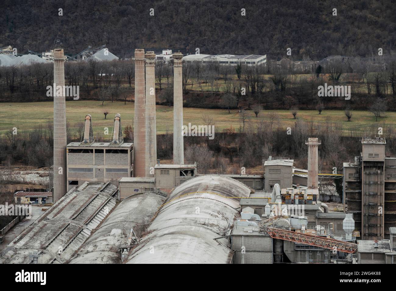 Industrial warehouse and factory with chimneys at the foot of the ...