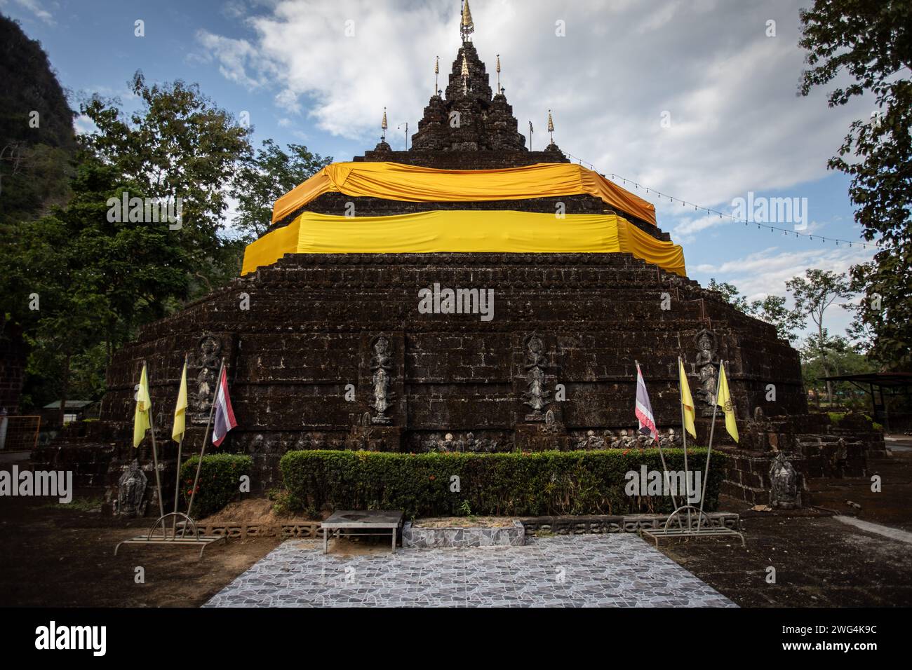 A view of a stone pagoda at the Wat Tham Pla Temple. Wat Tham Pla (Cave ...