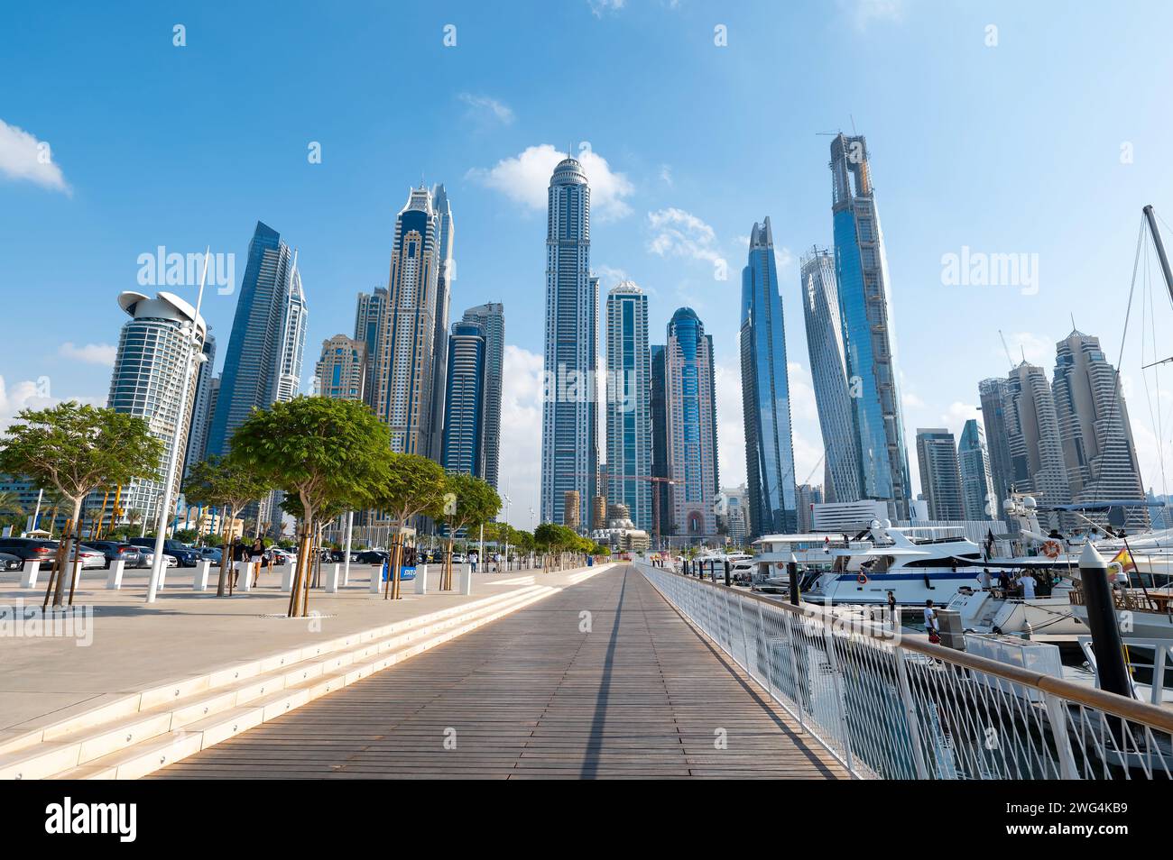 Dubai marina harbor on a sunny day in the UAE with a bustling ...