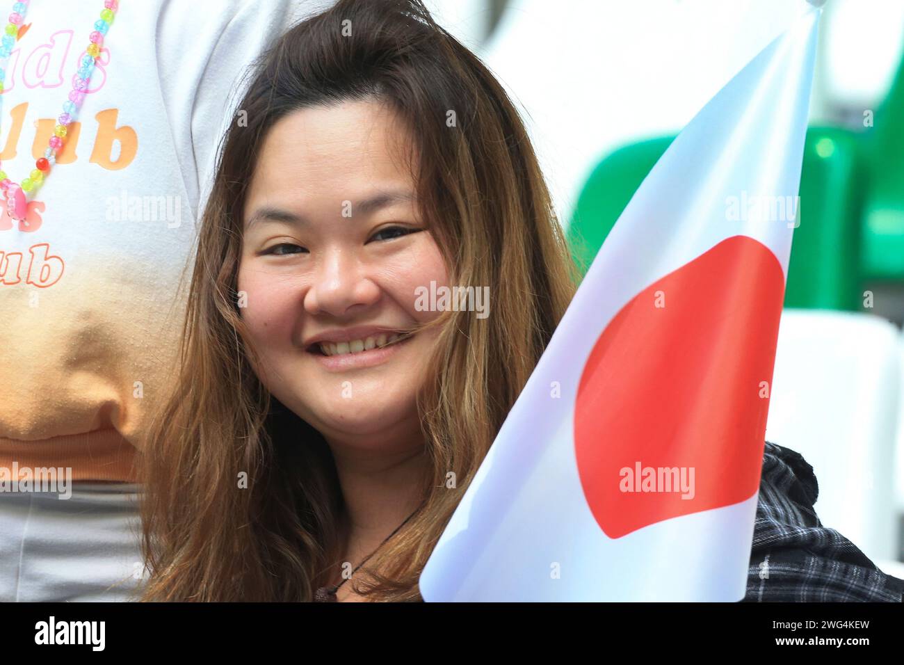 A Japanese fan holds her national flag during the Asian Cup ...