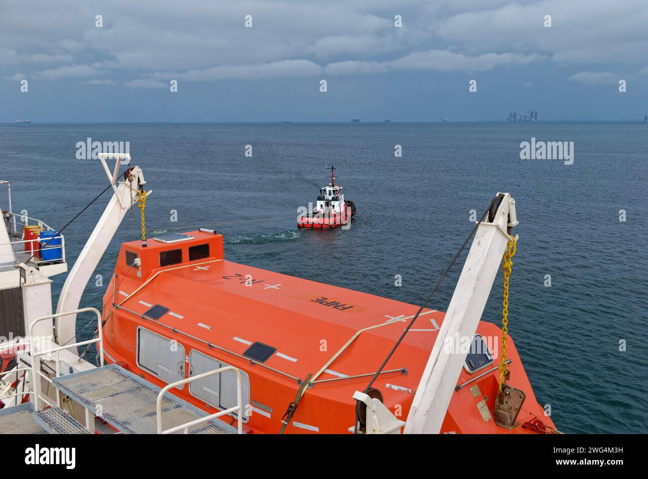 A Tug preparing to aid a Vessel departing Port Gentil in Gabon, framed ...