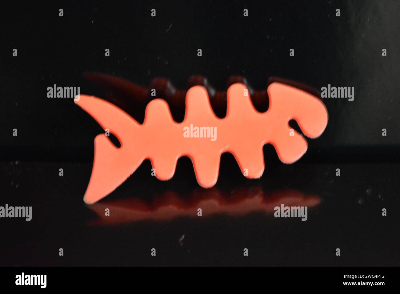 Red rubber plastic fish for wrapping headphones and a headset, reducing ...