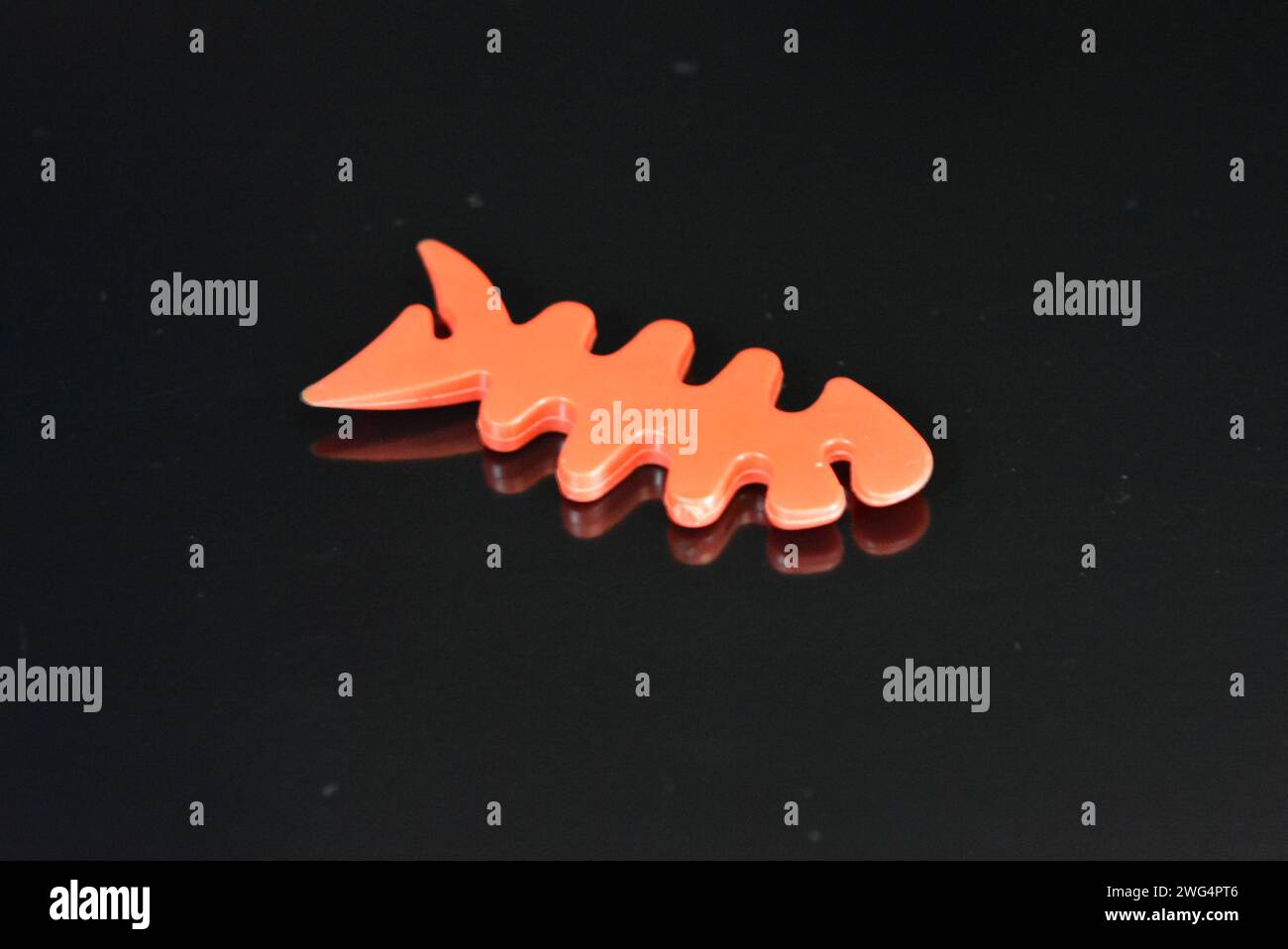 Red rubber plastic fish for wrapping headphones and a headset, reducing ...