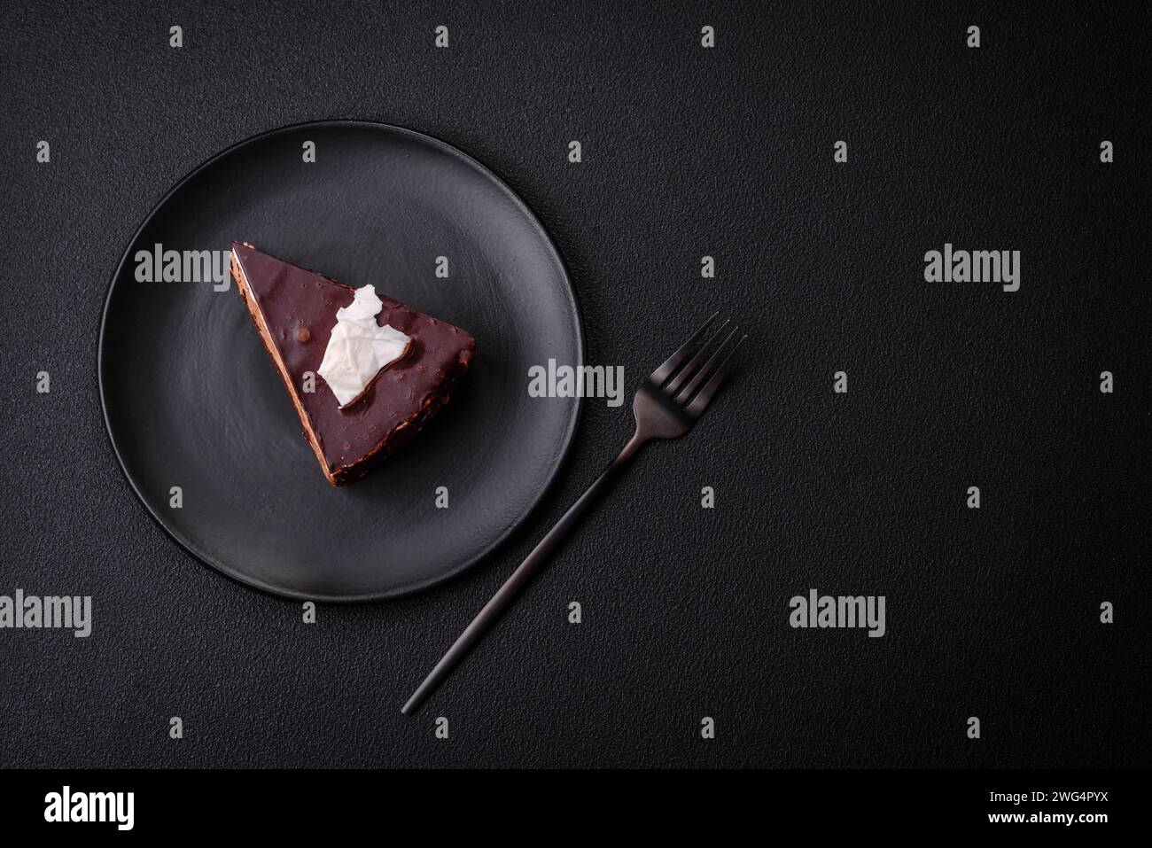 Piece of delicious sweet chocolate cake with sponge cake and cream on a ...