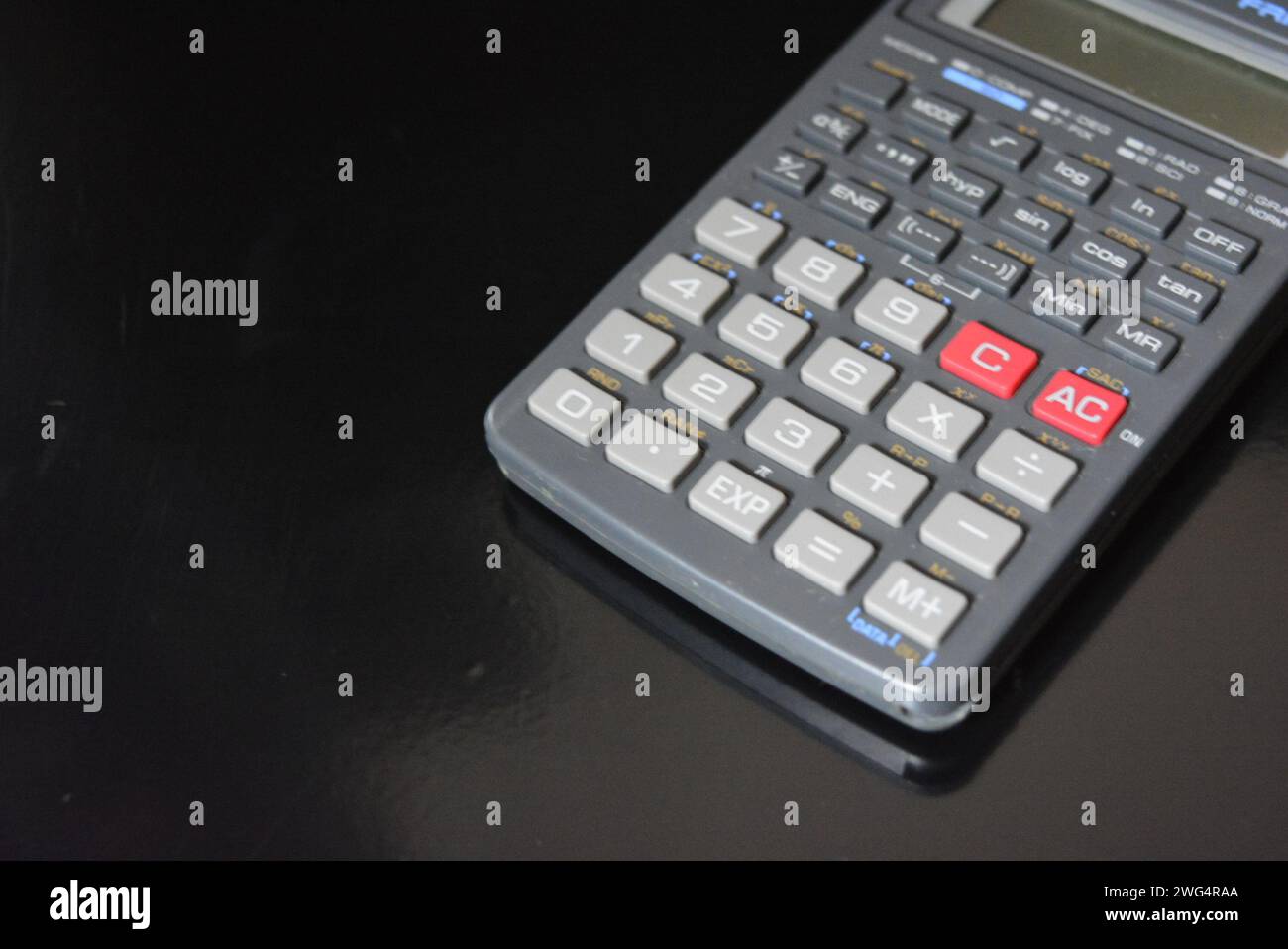 A gray calculator made of quality plastic with beautiful colors located ...