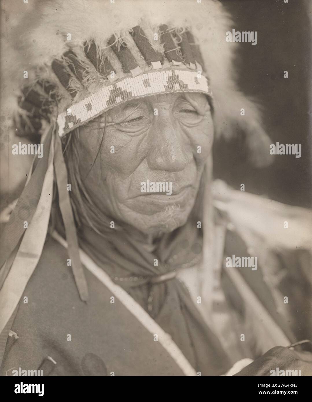 Black Road, 1905. Photograph shows Black Road, wearing headdress, head ...