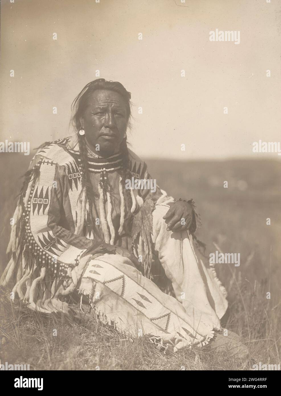 Good Stab, 1910. Photograph shows Good Stab, with braided hair, wearing ...