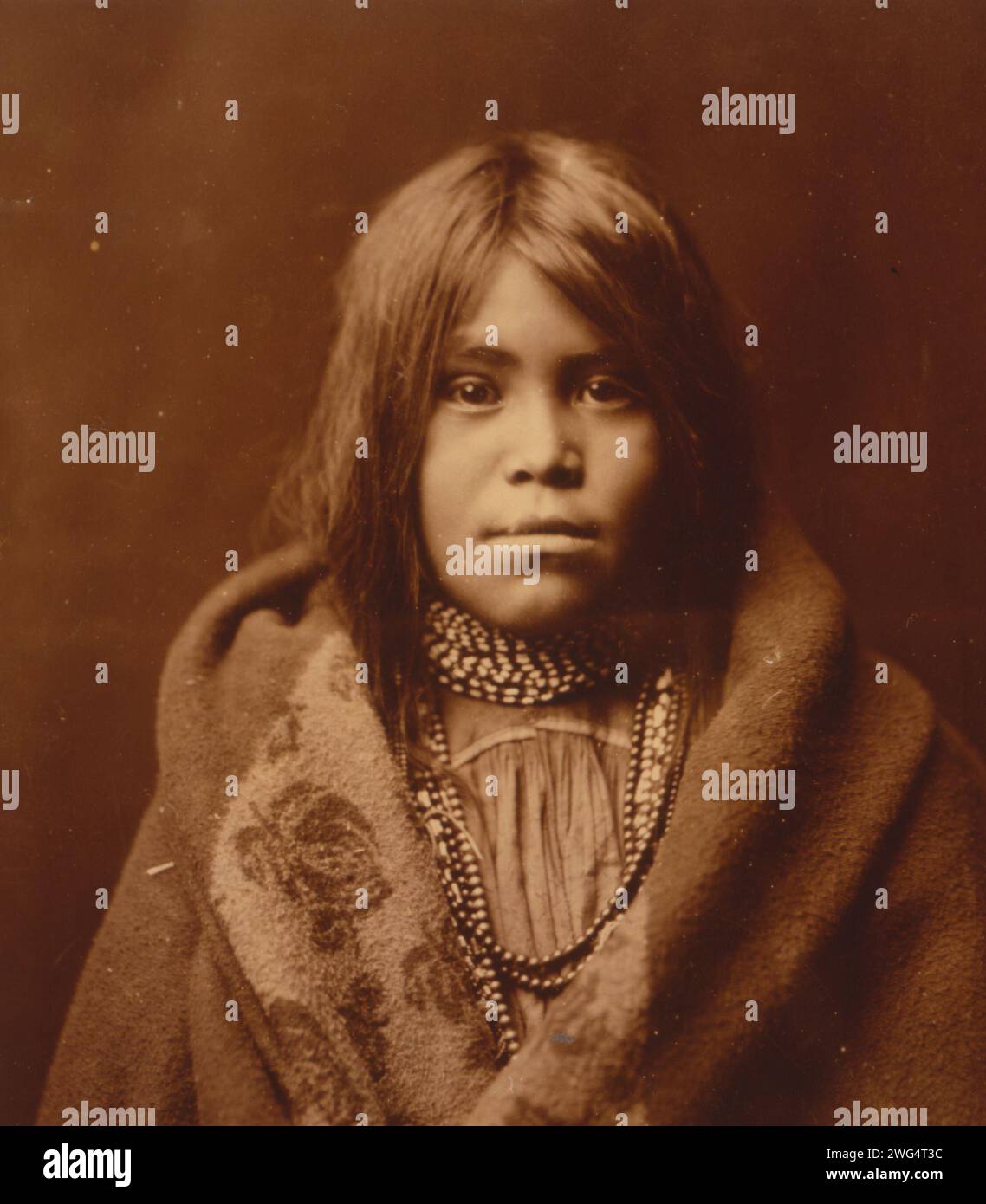 An Apache girl, head-and-shoulders portrait, facing front, wearing bead ...