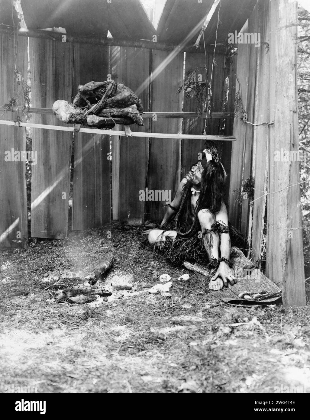 The drying mummy, 1910, c1910. Kwakiutl man inside board structure ...