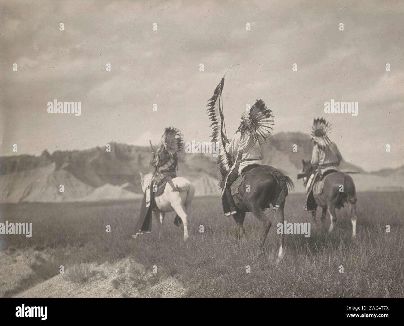 A Sioux war party, 1905. Photograph shows three warriors, wearing ...