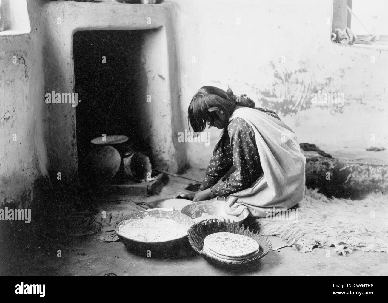 Women making traditional flat bread Black and White Stock Photos ...